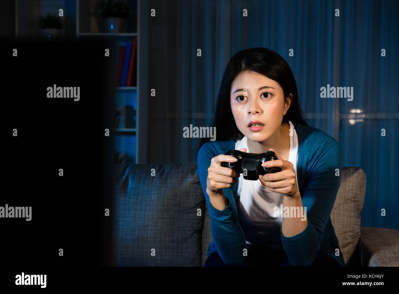 beautiful attractive girl holding joystick controller looking at ...