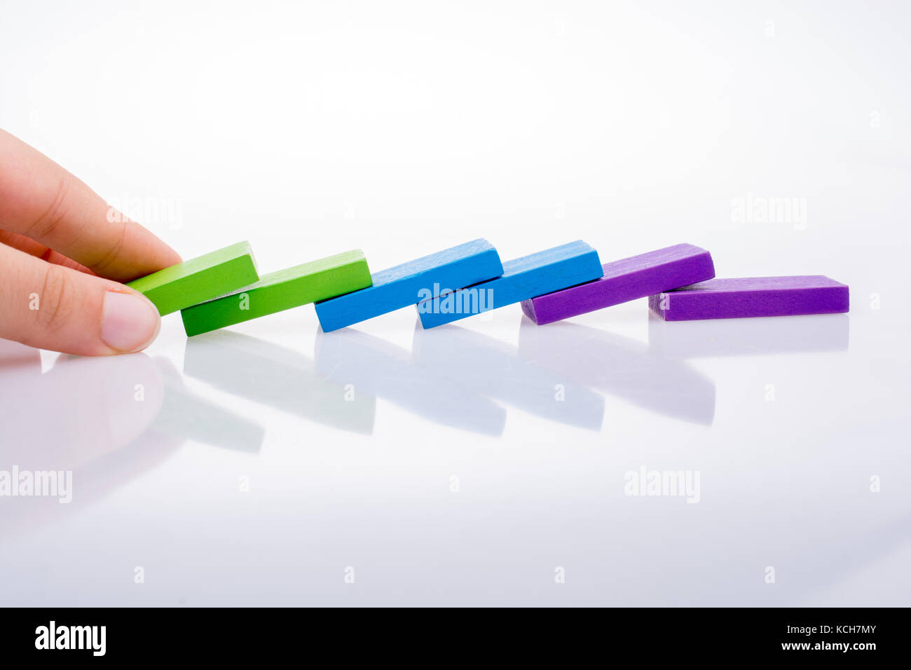 Colorful Domino Blocks in a line on a white background Stock Photo - Alamy