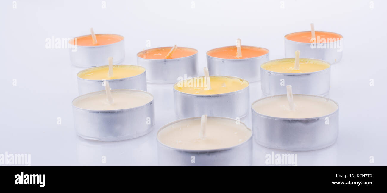 Colorful small Candles on a white background Stock Photo - Alamy