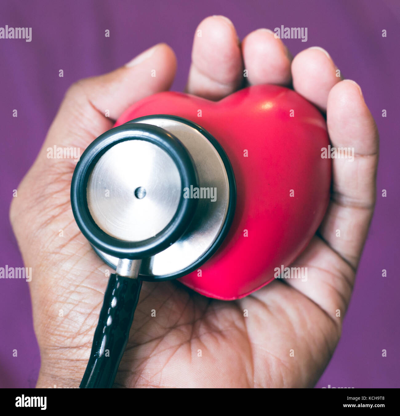 Stethoscope auscultate heart on hand Stock Photo - Alamy