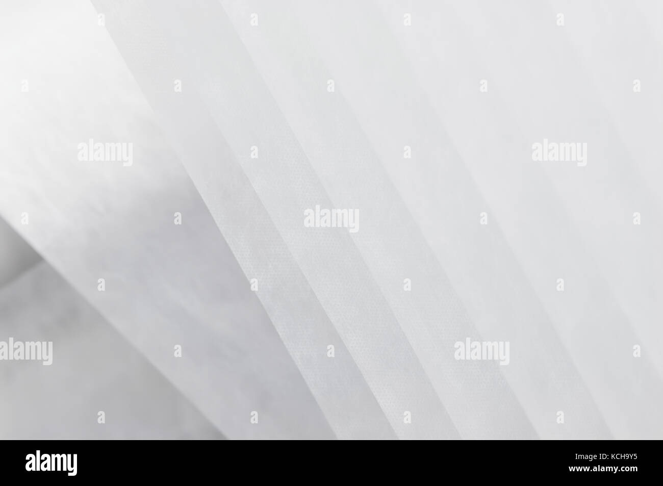 background of translucent white porous textile with straight lines ...