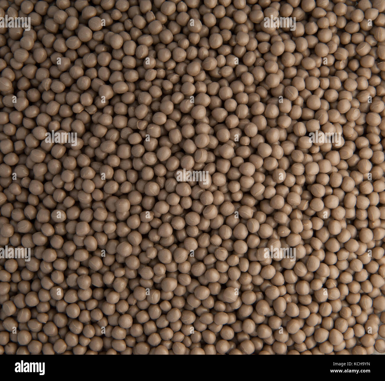 background of small plastic pellets brown colored Stock Photo - Alamy