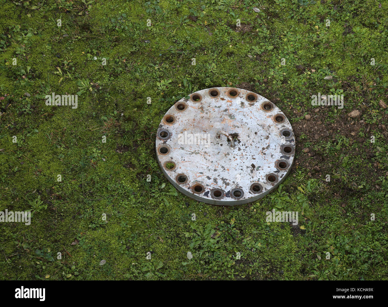 circular shaped cast iron lid on the lawn hides a secret trap of a ...