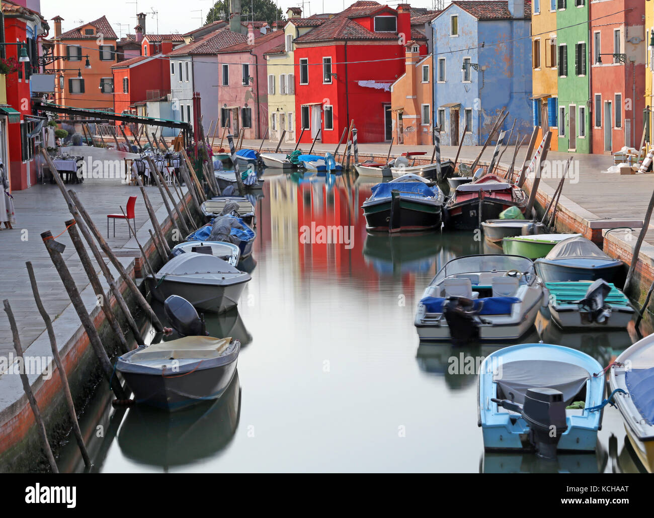 the navigable canal and the colorful houses of the BURANO island near ...