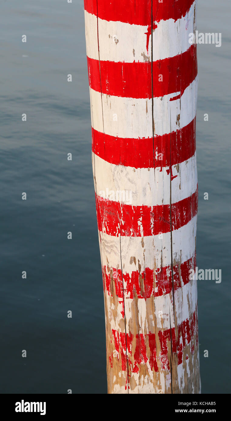 red and white pole called Bricola in italian language to moor the boat ...