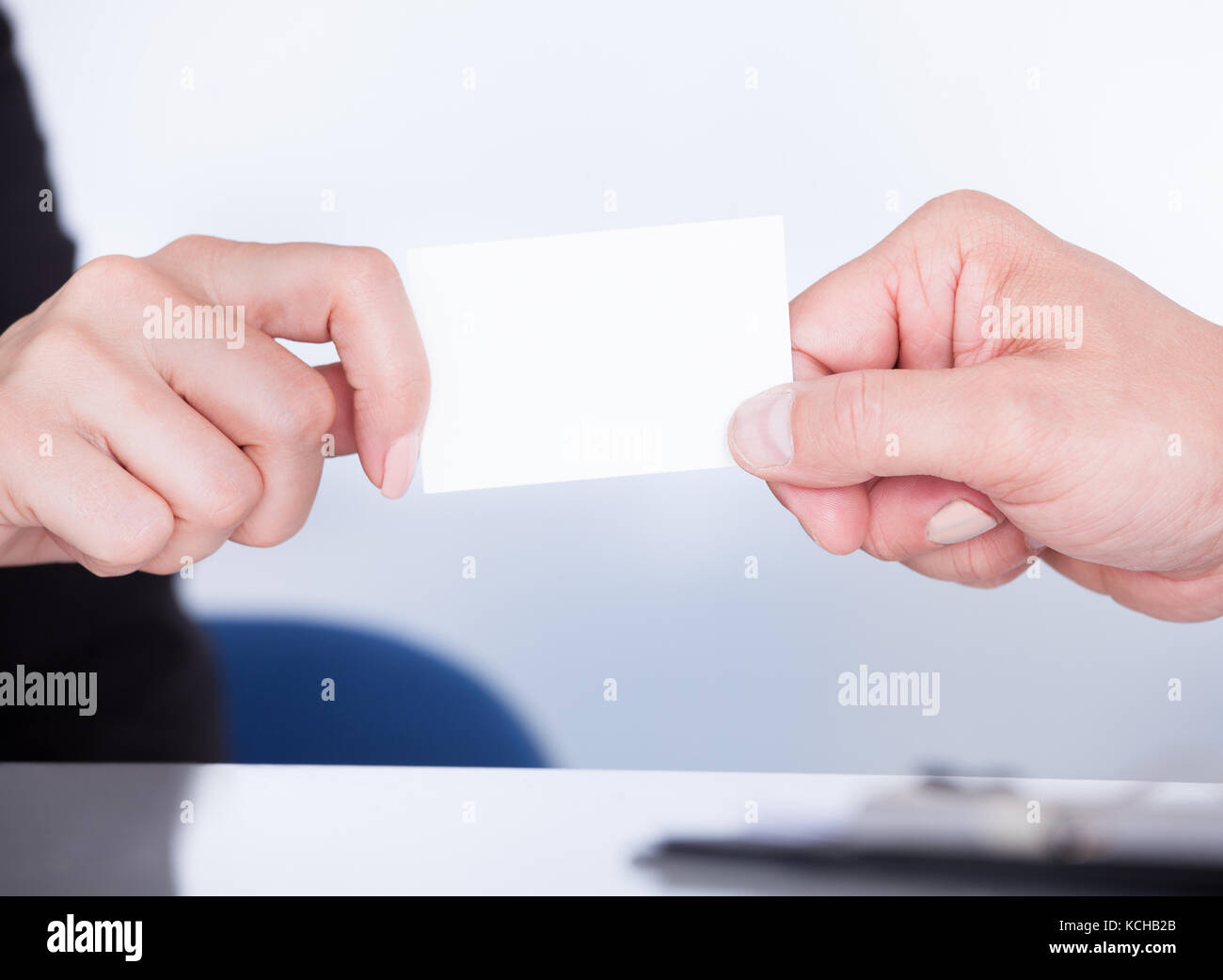 Two Happy Businesspeople Exchanging Visiting Card In Office Stock Photo ...