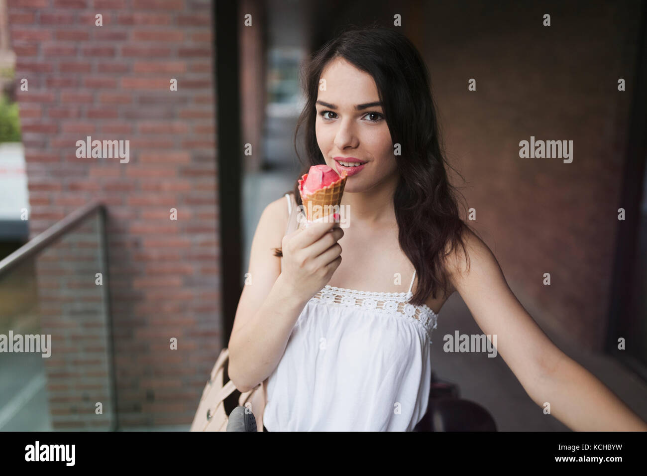 Portrait of pretty girl eating ice cream Stock Photo - Alamy