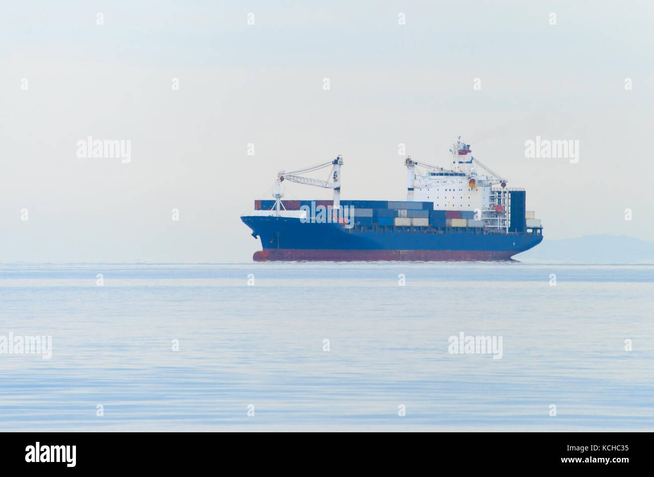 Industrial ship full of containers in the sea Stock Photo - Alamy
