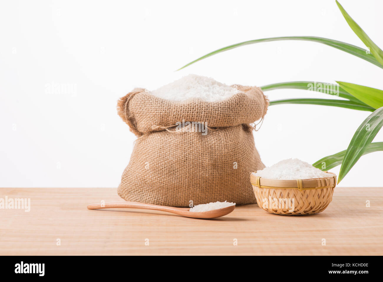Jasmine white rice in sack isolated on white background Stock Photo - Alamy