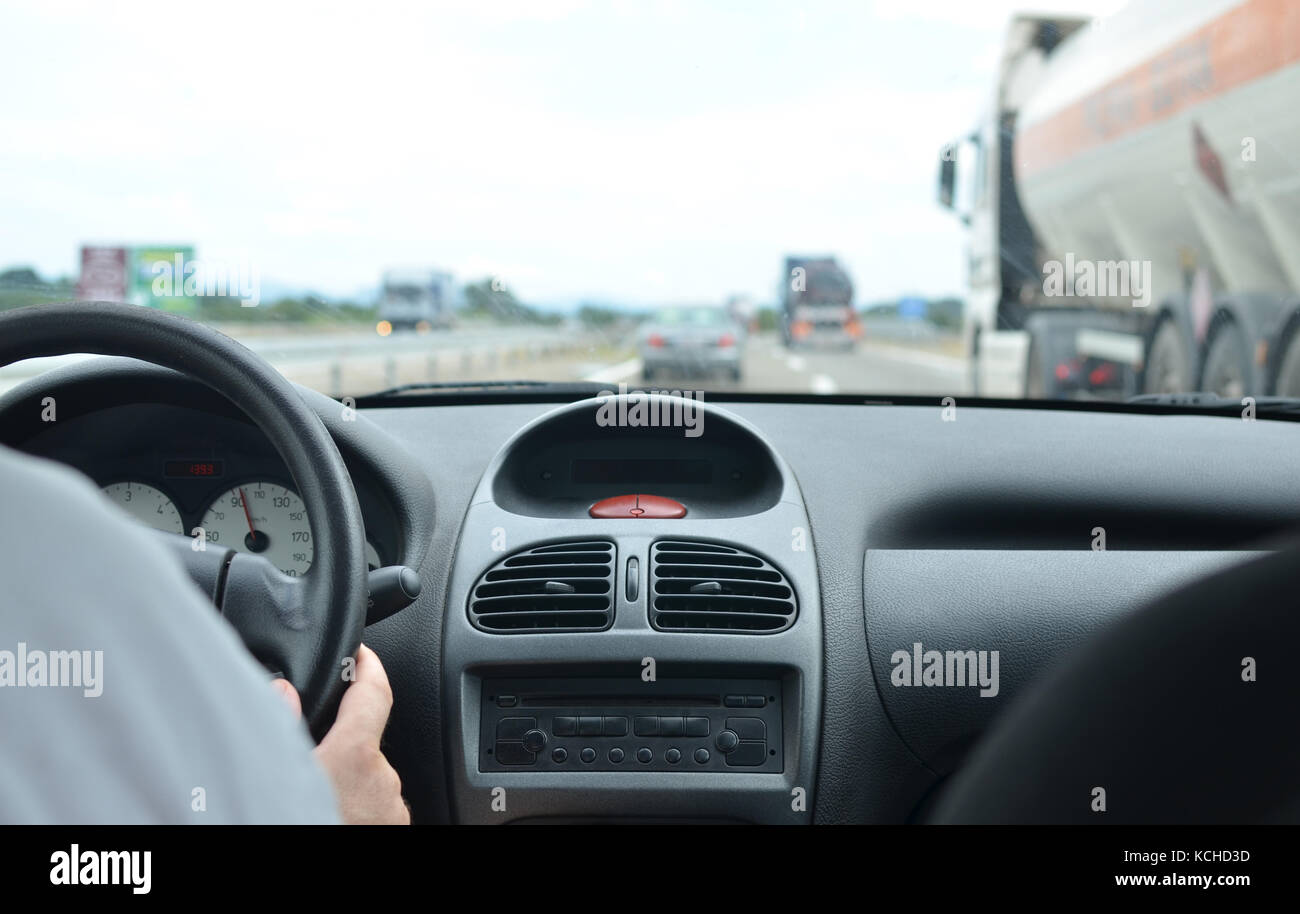 Man driving a car on a highway in traffic jam time and with other ...