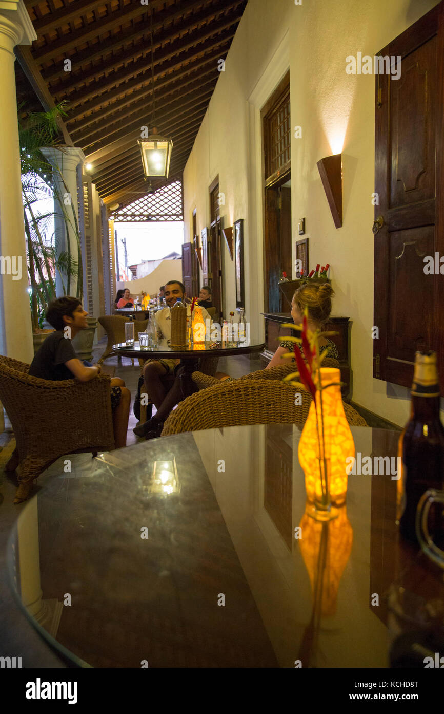 Evening drinks colonial style veranda bar of Galle Fort Hotel, historic ...