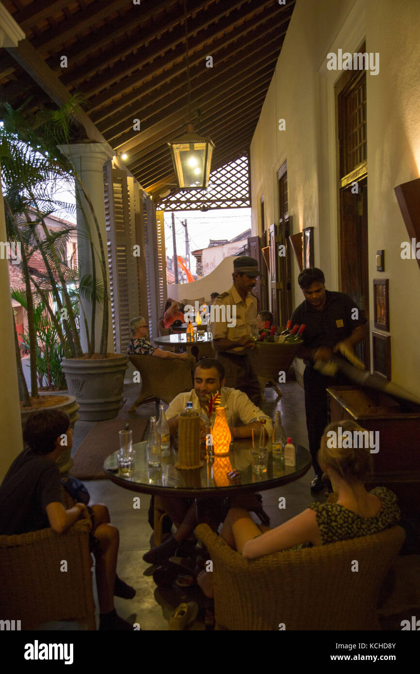 Evening drinks colonial style veranda bar of Galle Fort Hotel, historic ...