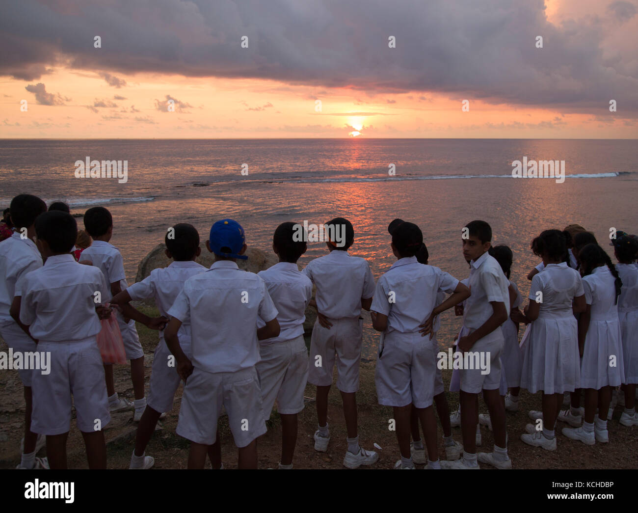 School group on fort ramparts at sunset in historic town of Galle, Sri ...