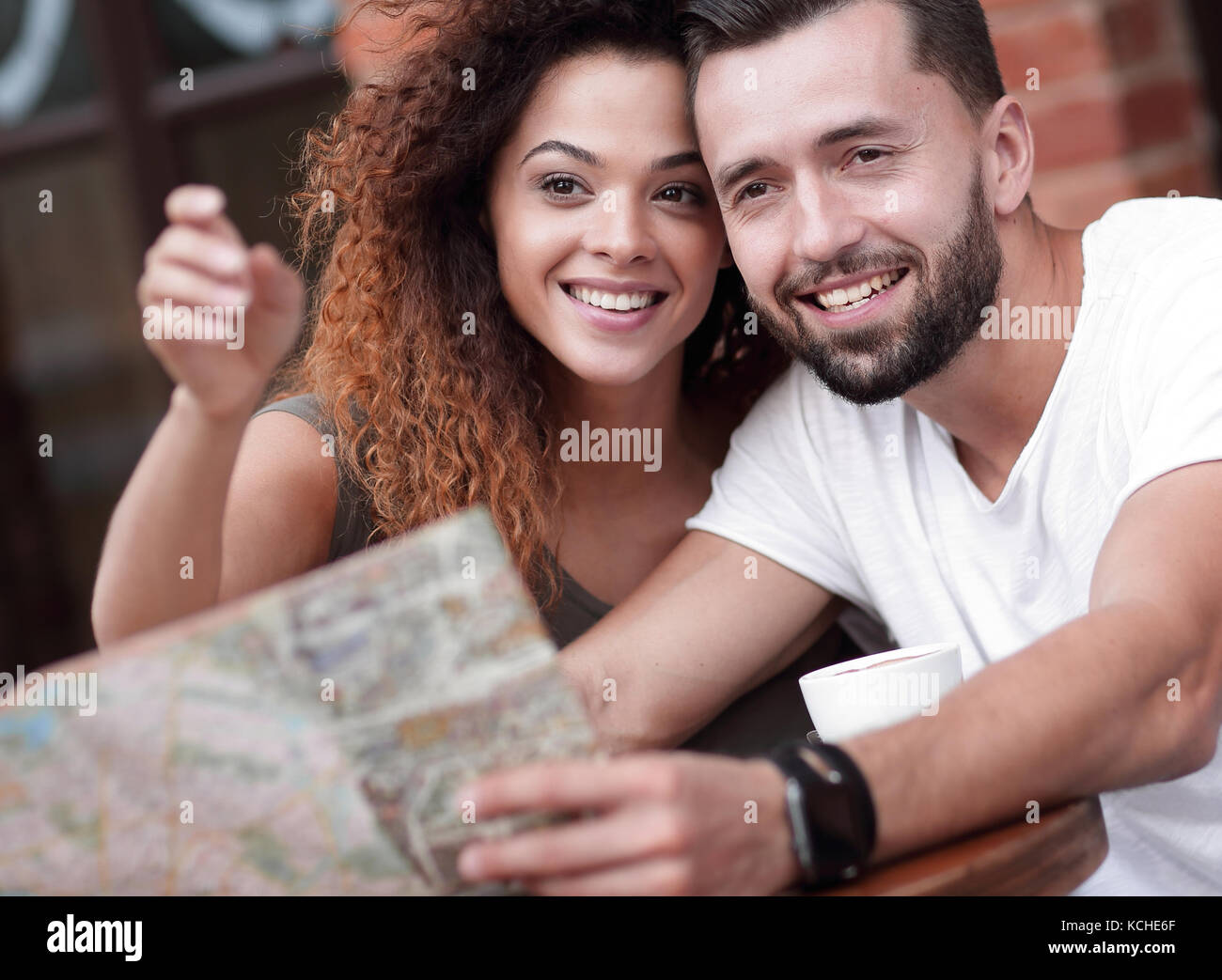 A picture of tourists looking at map in a cafe Stock Photo - Alamy