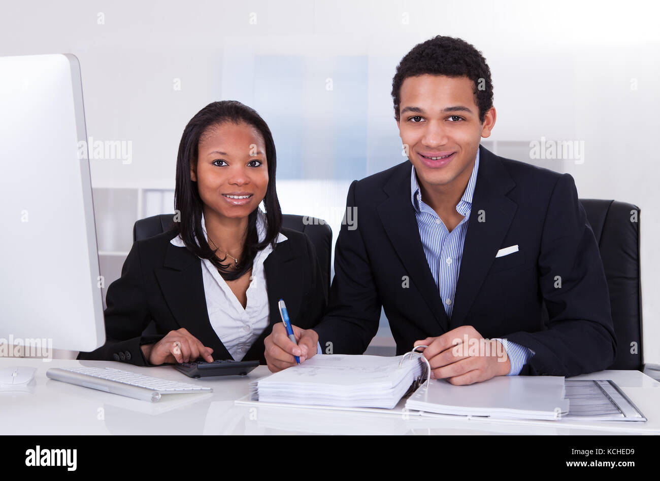 Two Business People Calculating Finance Together In Office Stock Photo ...