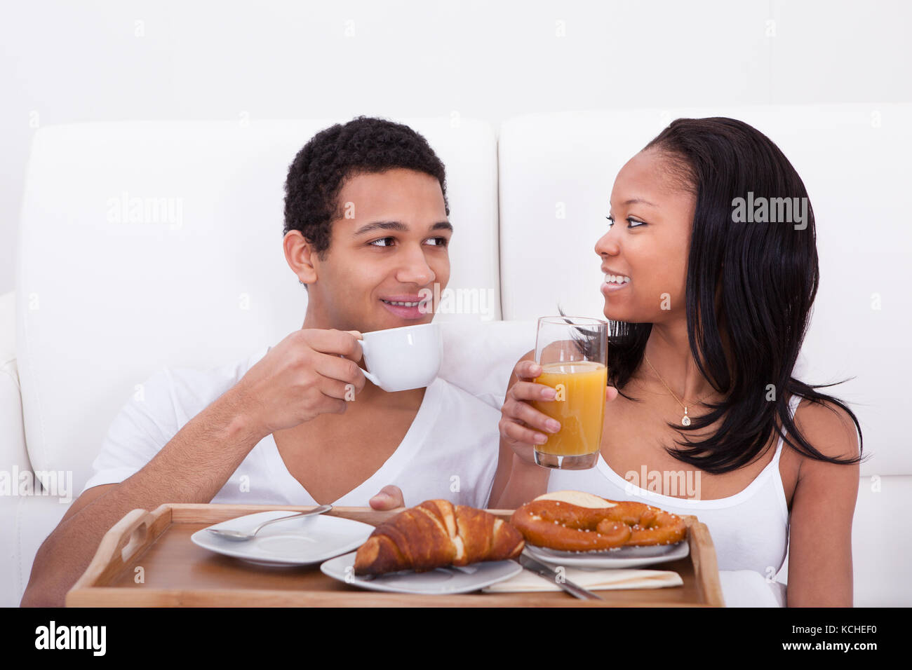 Portrait Of African Couple Having Breakfast In Bedroom Stock Photo - Alamy