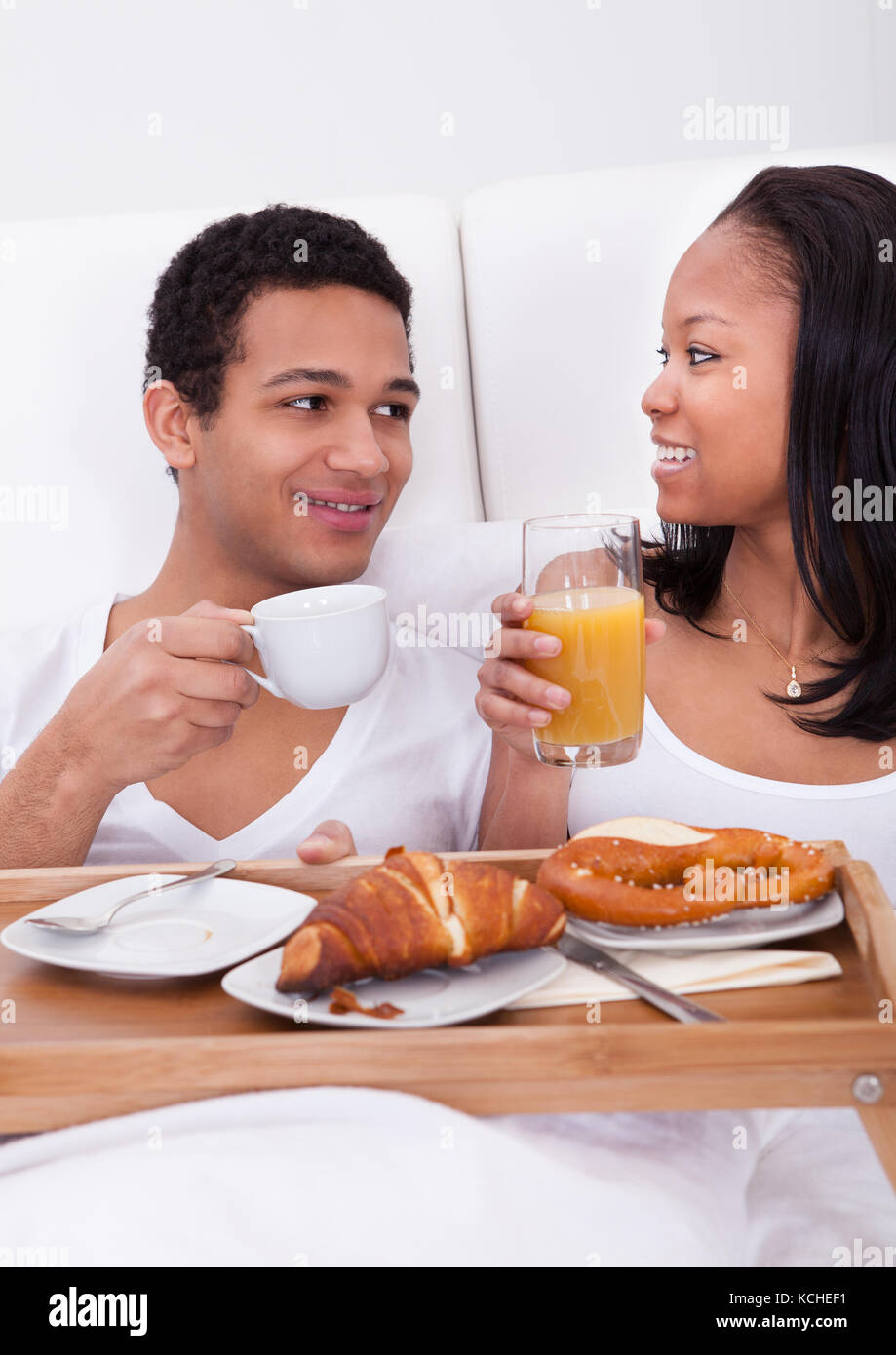 Portrait Of African Couple Having Breakfast In Bedroom Stock Photo - Alamy