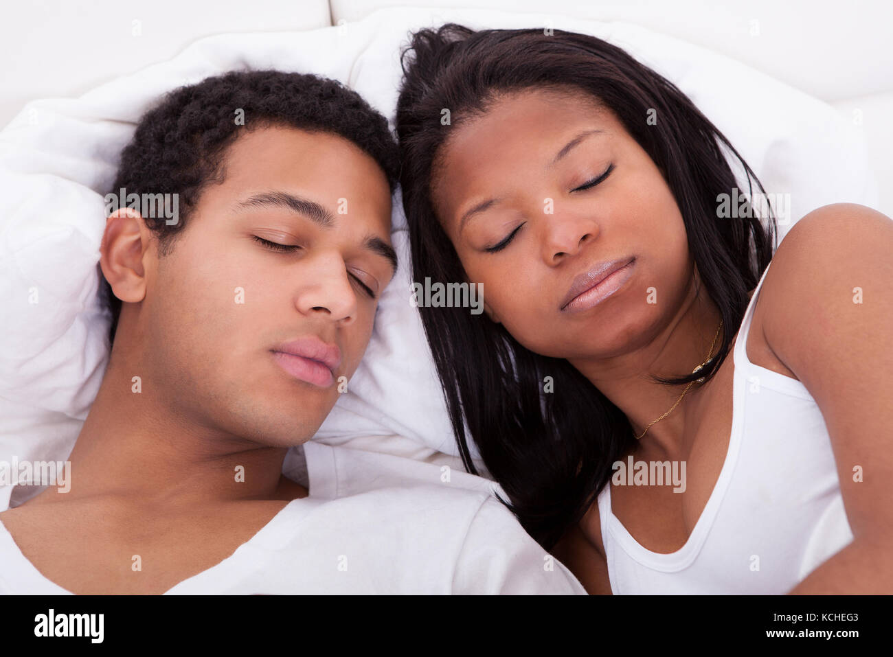 Beautiful couple sleeping on bed hi-res stock photography and images ...