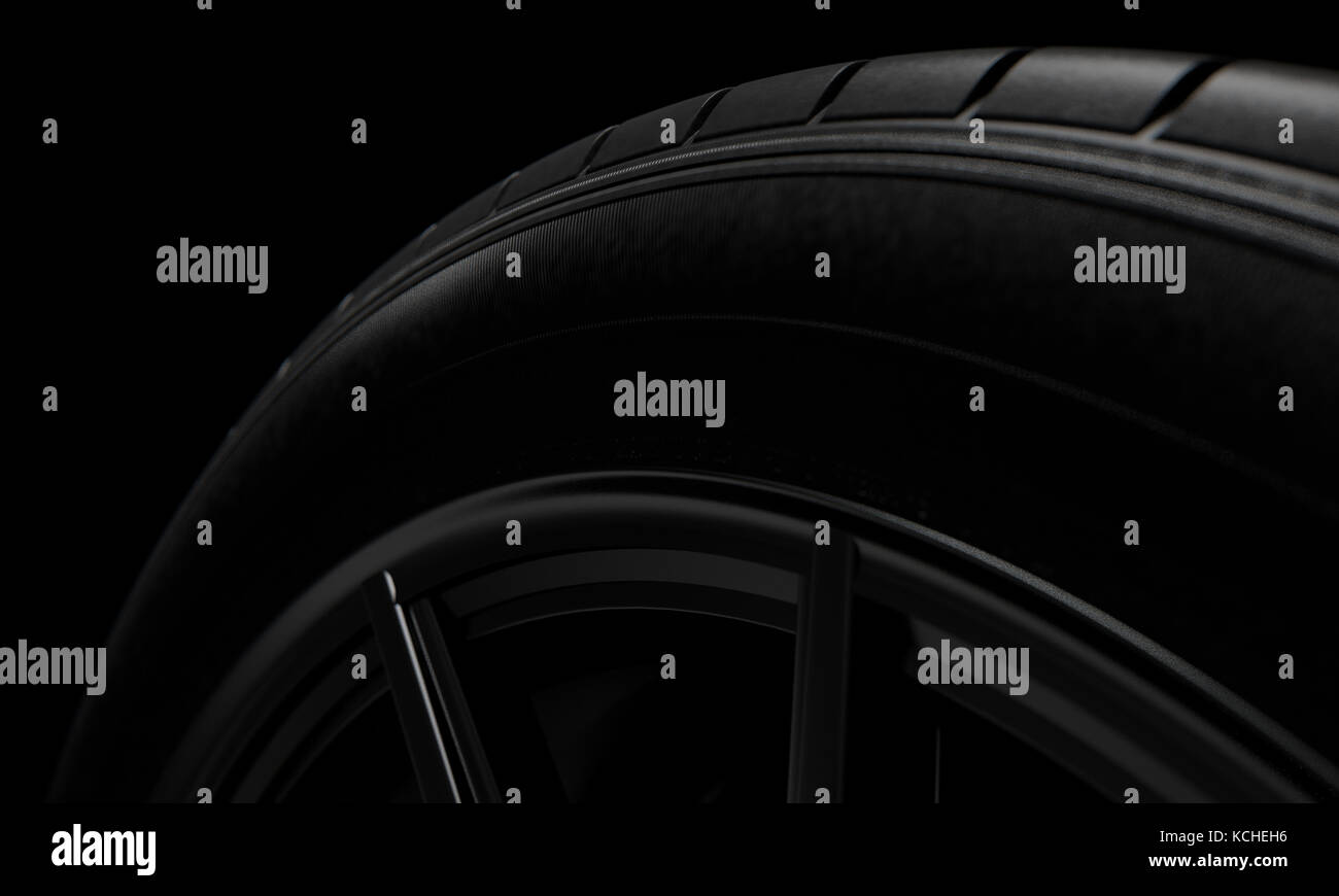 A modern sporty low profile tire on a dark moody studio background - 3D ...
