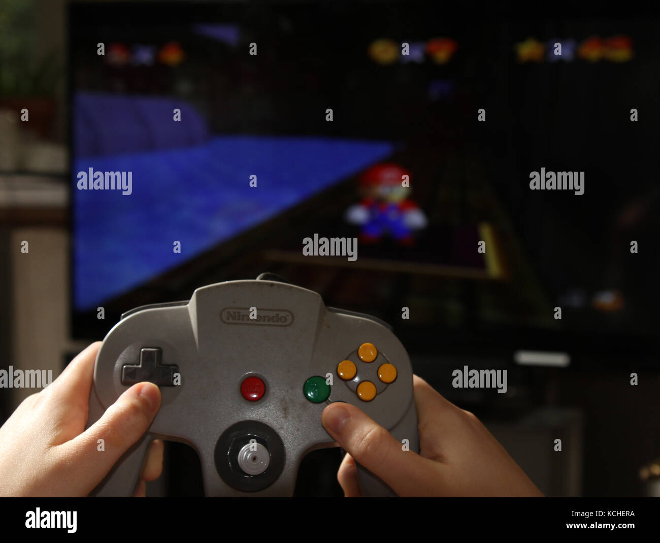 Teenager playing with a Nintendo N64 video game Stock Photo - Alamy