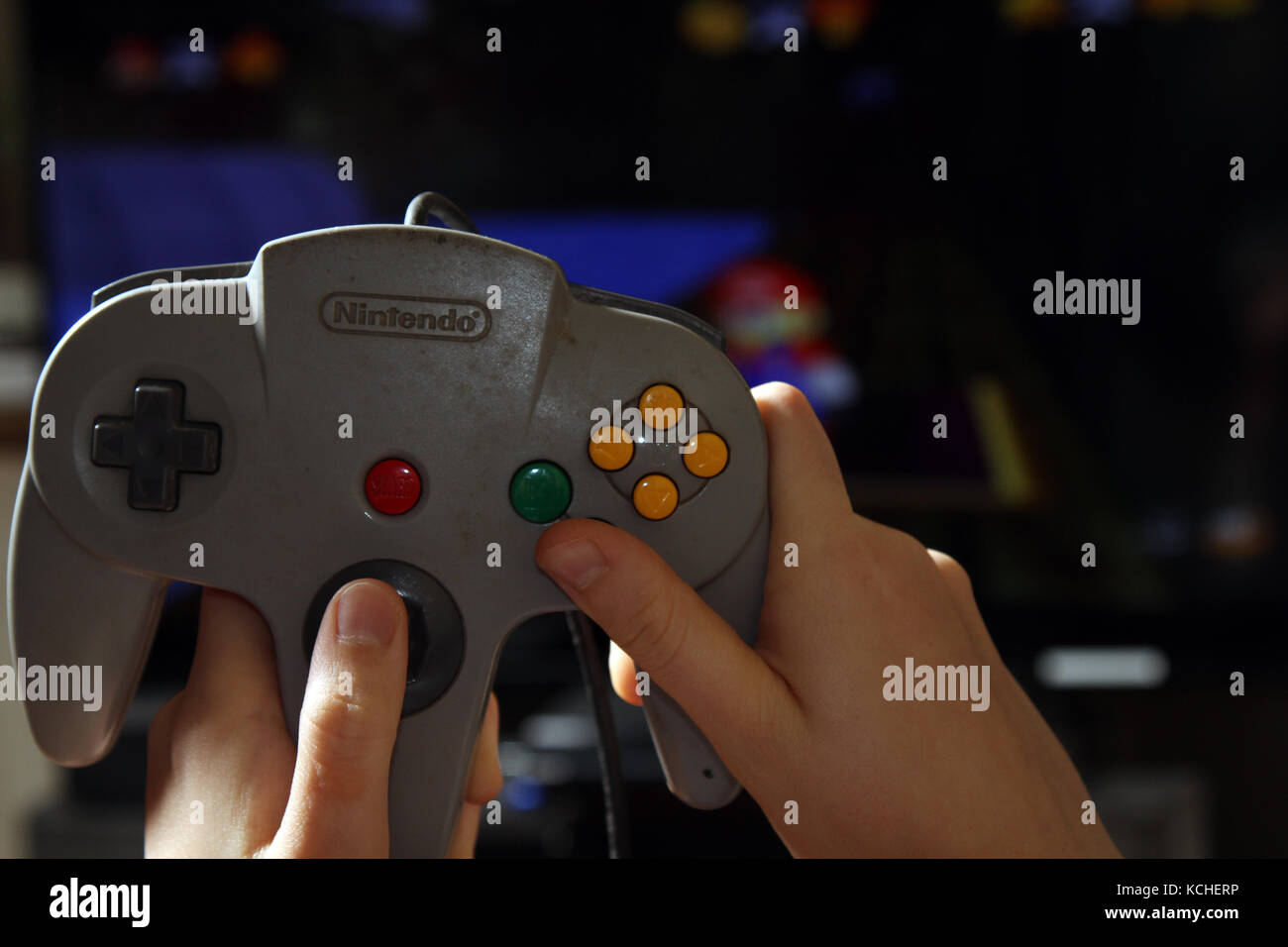 Teenager playing with a Nintendo N64 video game Stock Photo - Alamy