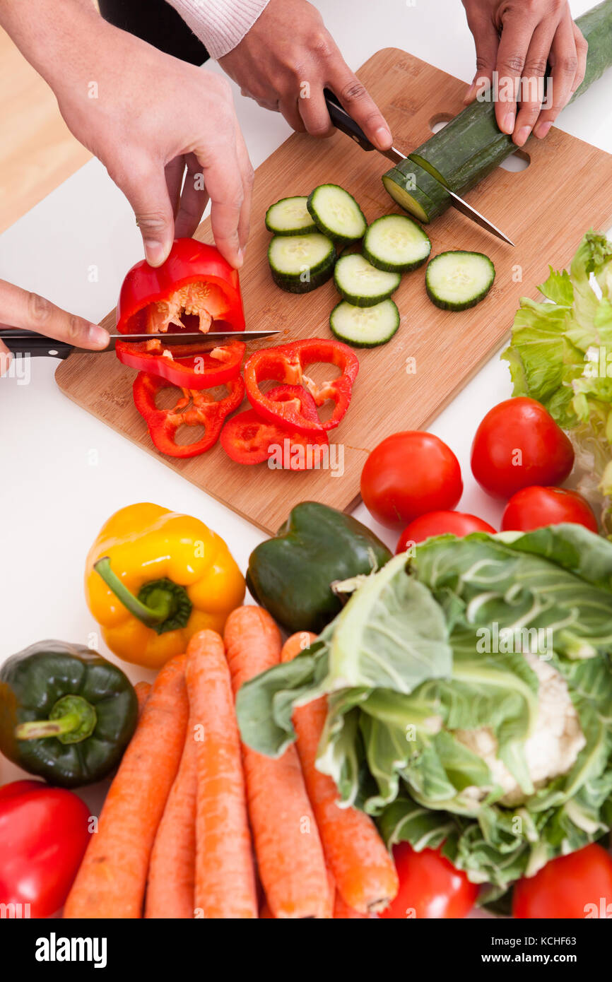 Portrait Of Couple Chopping Vegetables In Kitchen Stock Photo - Alamy