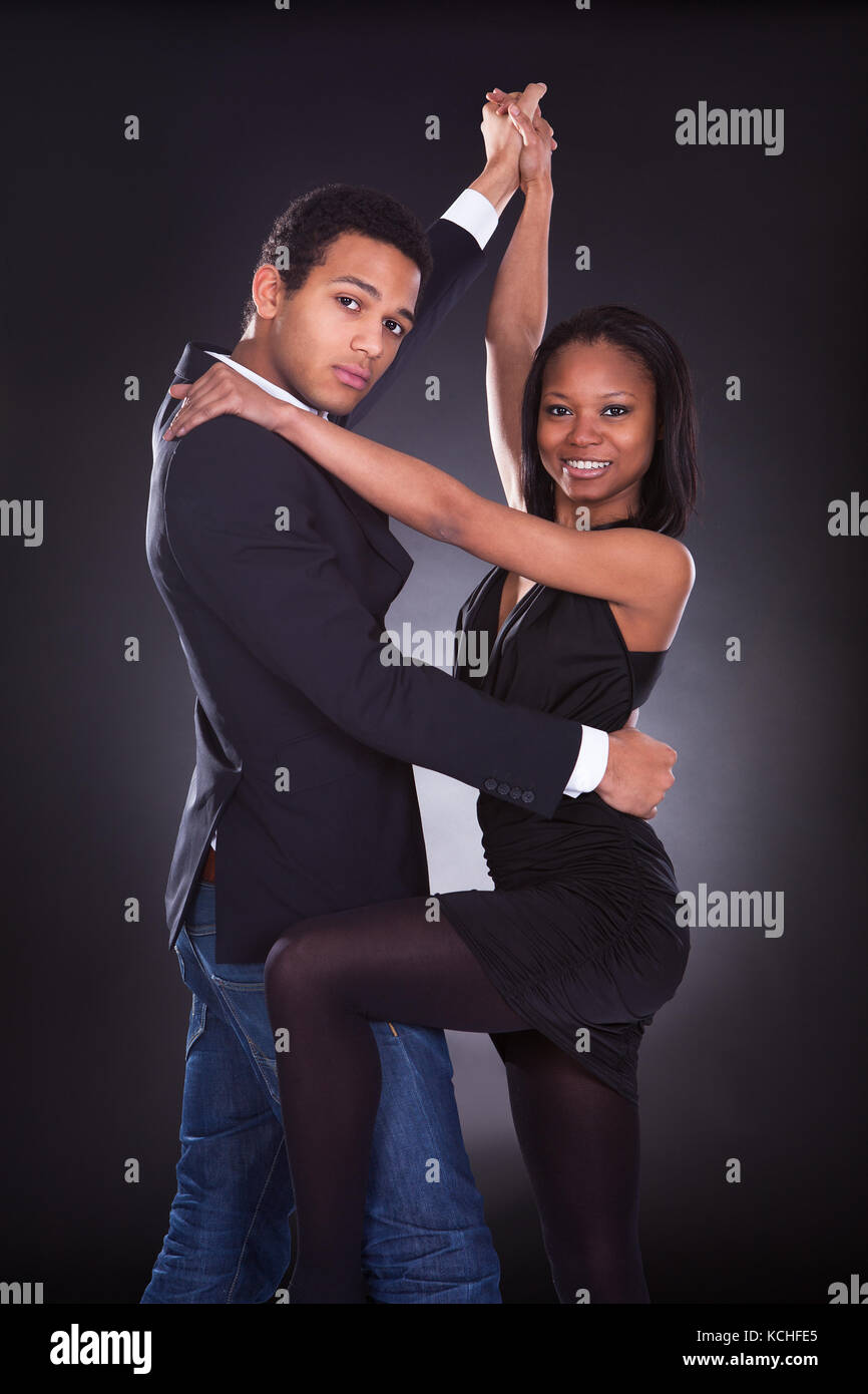 Portrait Of African Couple Dancing Over Grey Background Stock Photo - Alamy