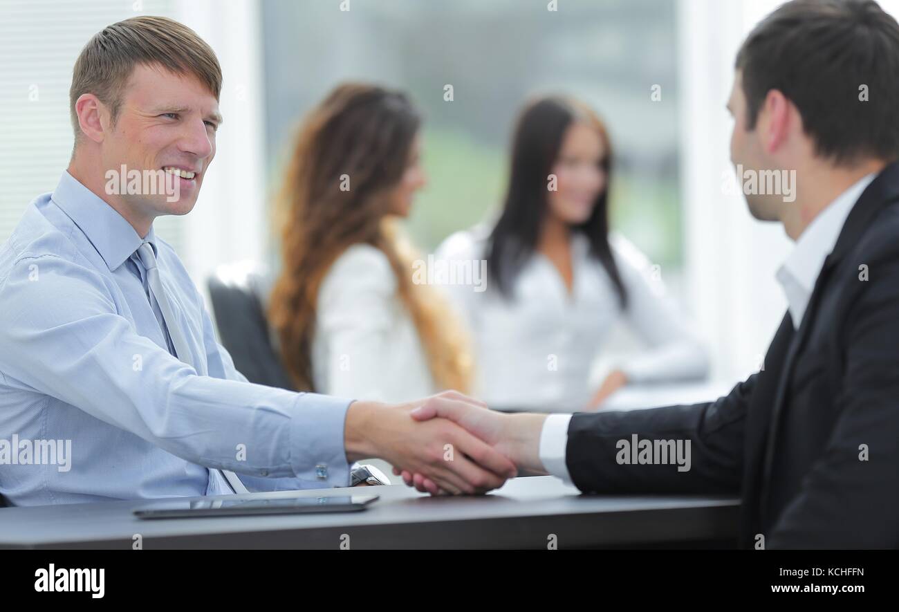 handshake business partners at your Desk Stock Photo - Alamy