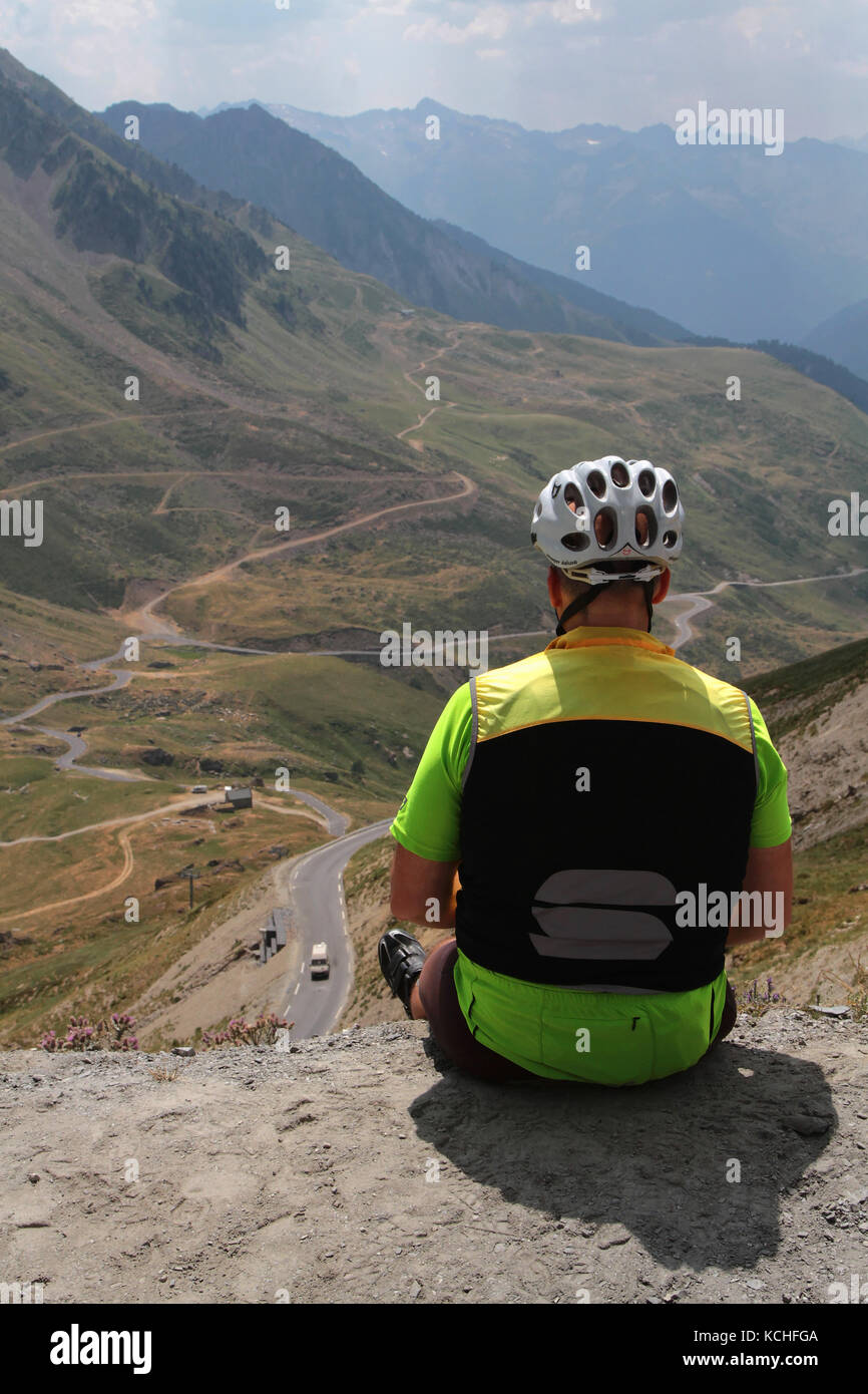 TOURMALET, FRANCE, July 16, 2015 : A cyclist rests at the pass, looking ...