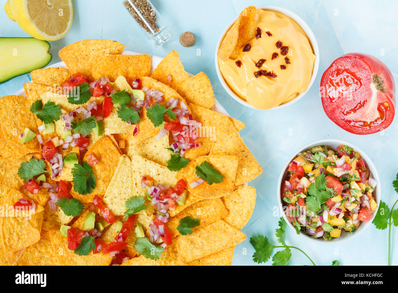 Yellow corn chips nachos with cheese sauce and salsa sauce. Mexican ...