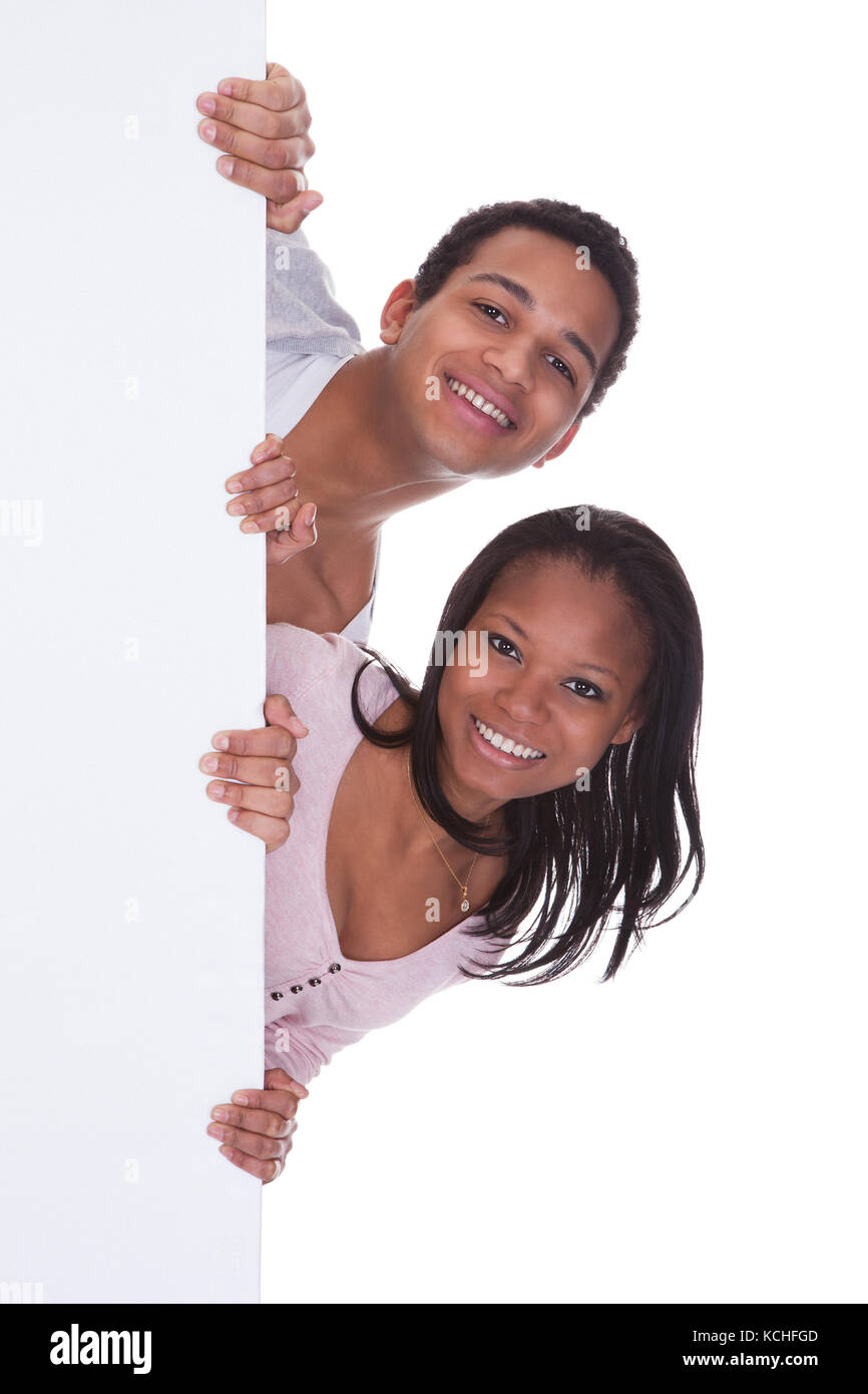 Young Couple Holding Placard Over White Background Stock Photo - Alamy Young Couple Holding Placard Over White Background Stock Photo - Alamy