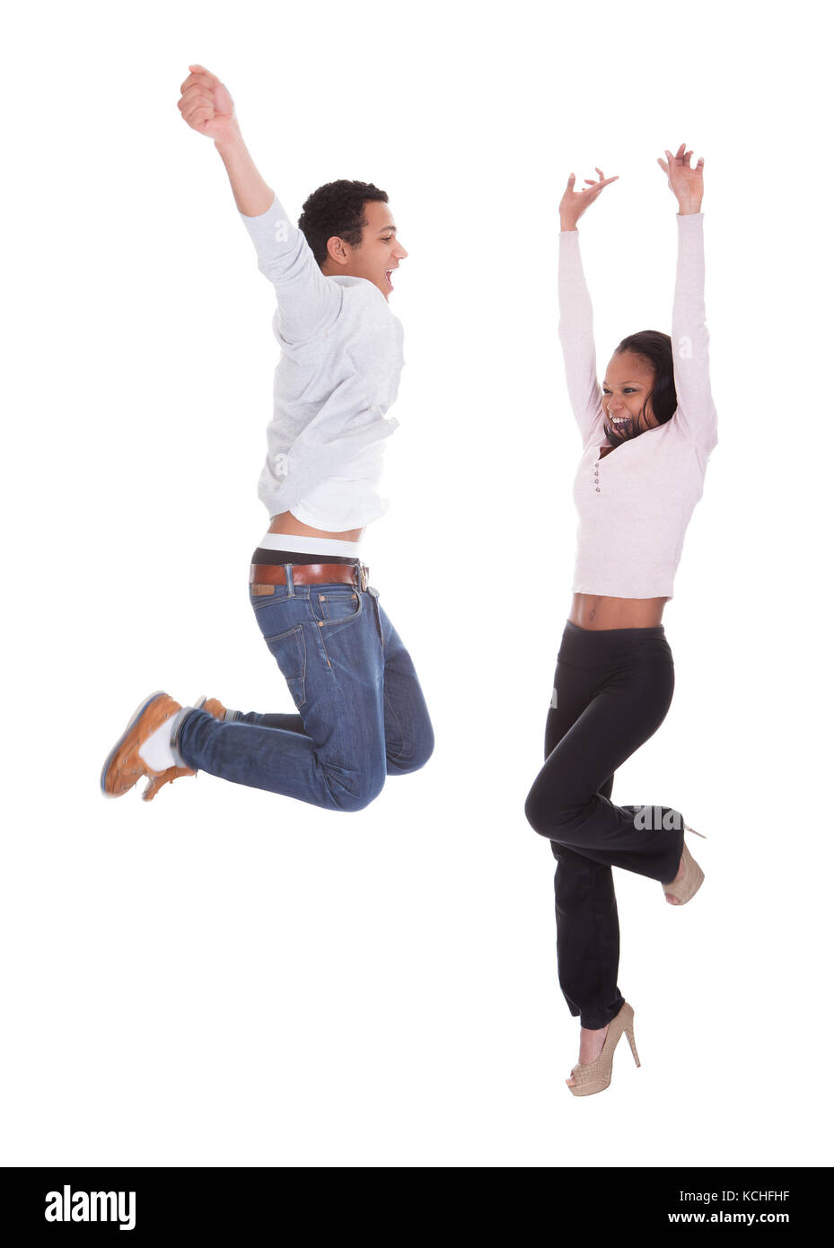 Young Couple Jumping In The Air Over White Background Stock Photo - Alamy