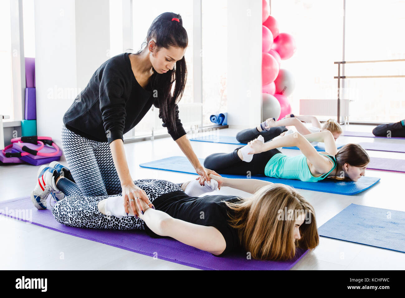 Young women doing stretching exercises in the aerobics class on the ...