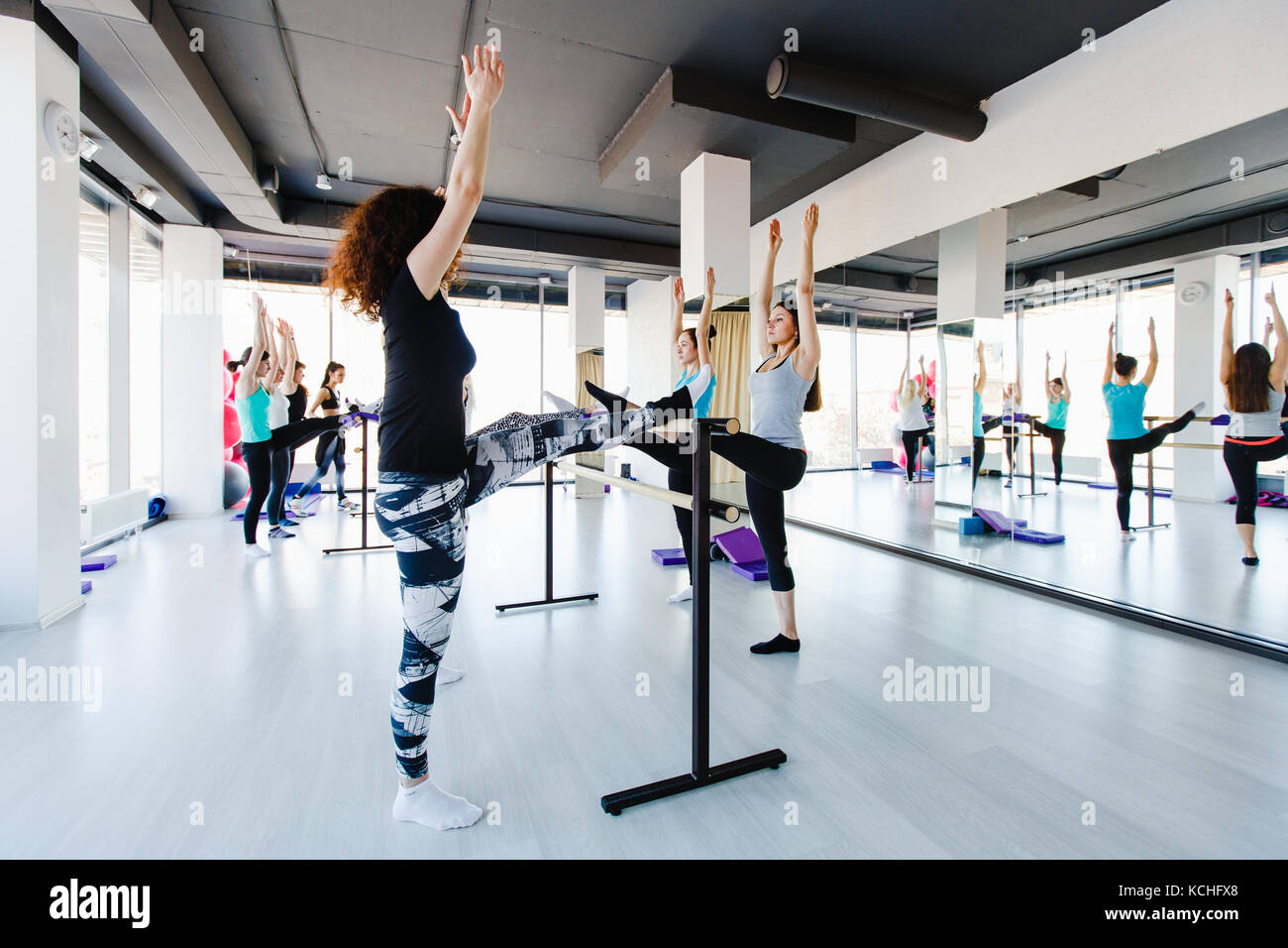 Young women doing stretching exercises in the aerobics class on the ...
