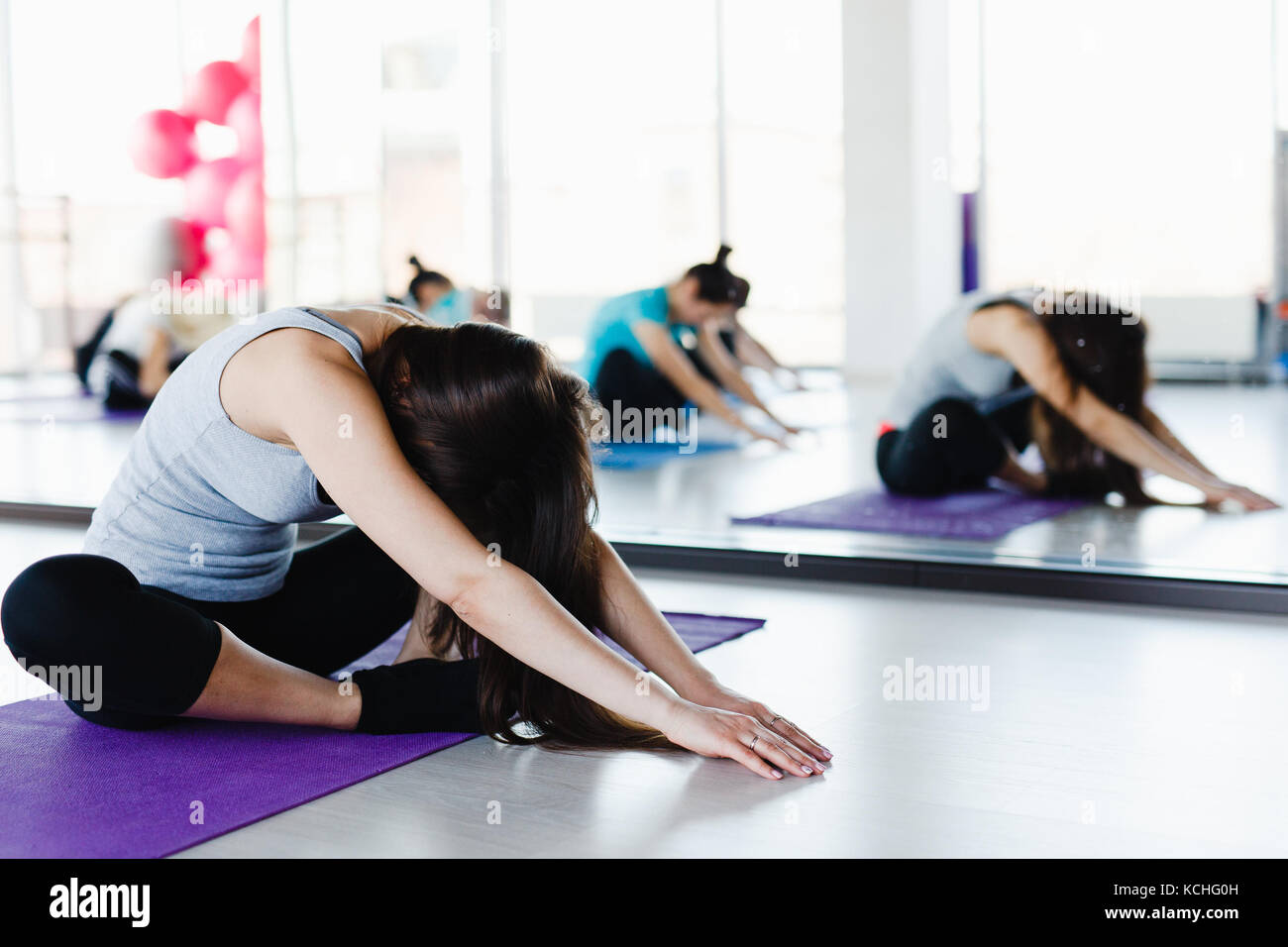 Young women doing stretching exercises in the aerobics class on the ...