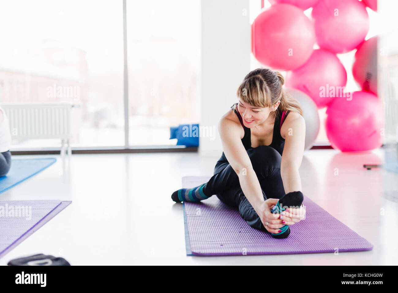 Young women doing stretching exercises in the aerobics class on the ...