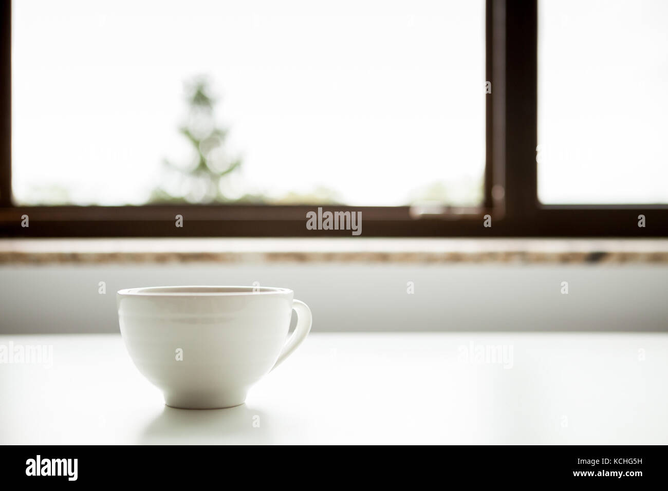 Coffee mug on a window sill Stock Photo - Alamy