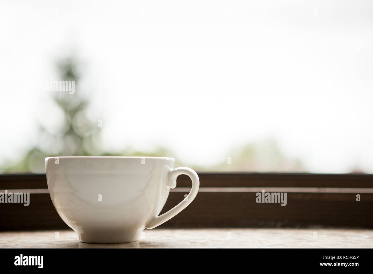 Coffee mug on a window sill Stock Photo - Alamy
