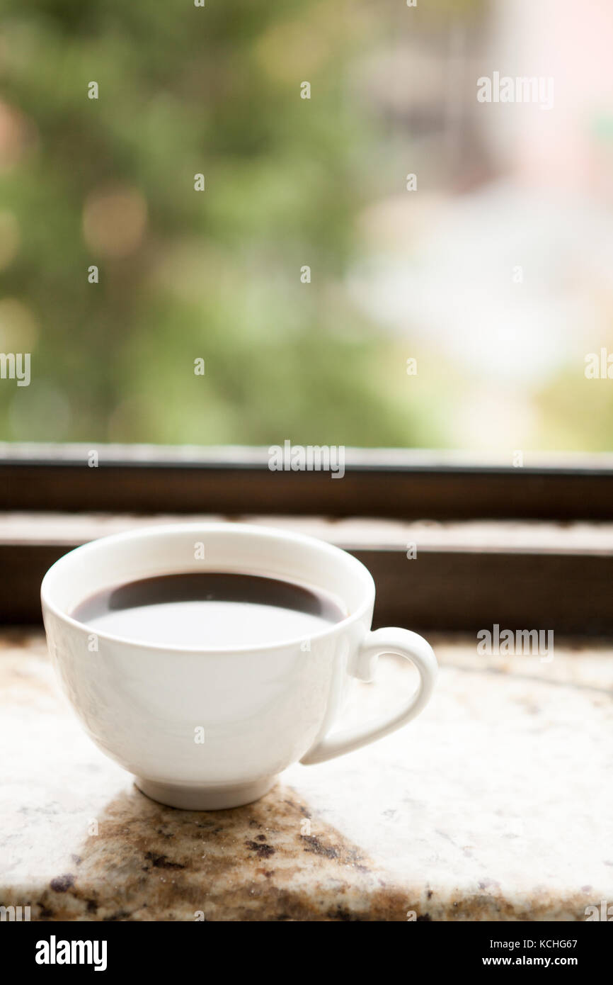 Coffee mug on a window sill Stock Photo - Alamy