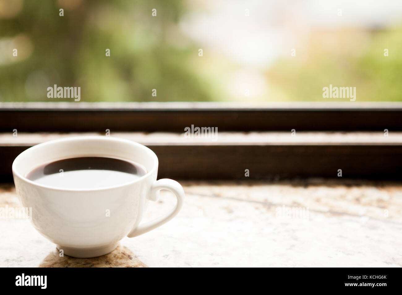Coffee mug on a window sill Stock Photo - Alamy