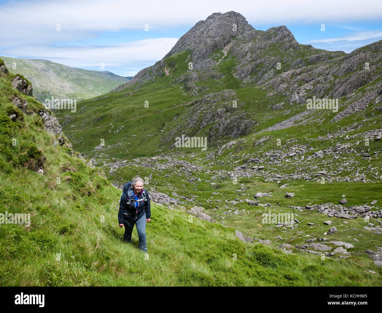 A female hill walker in upper Cwm Bochlwyd with a view to Tryfan, Ogwen ...