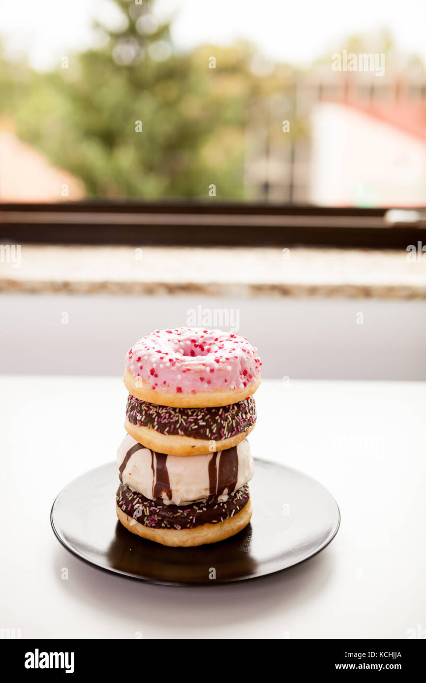 Plate with donuts next to window Stock Photo - Alamy