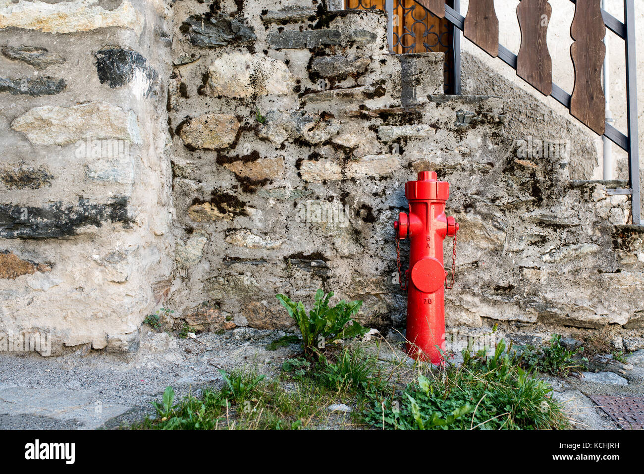 fire hydrant near a brick wall, alpine little town scene Stock Photo ...