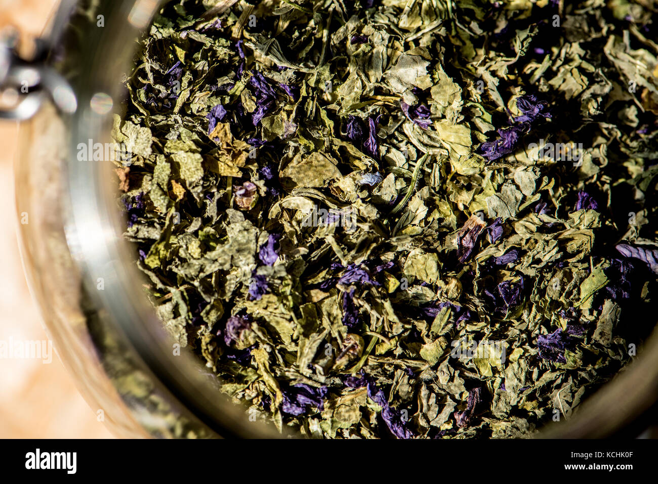 glass jar full of mallow, leaves and flowers for healthy infusion ...