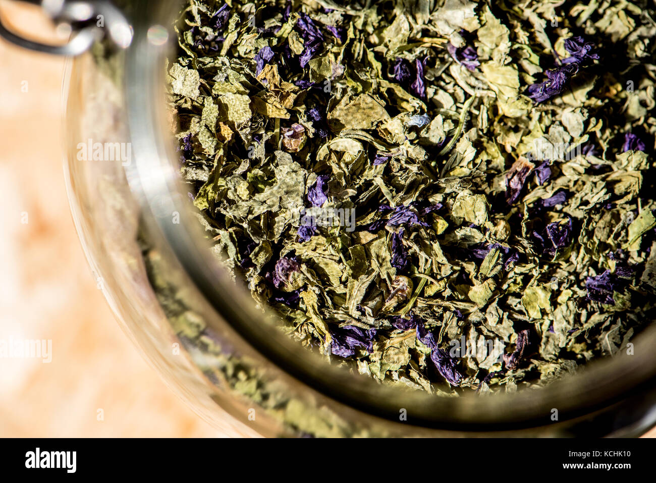 glass jar full of mallow, leaves and flowers for healthy infusion ...