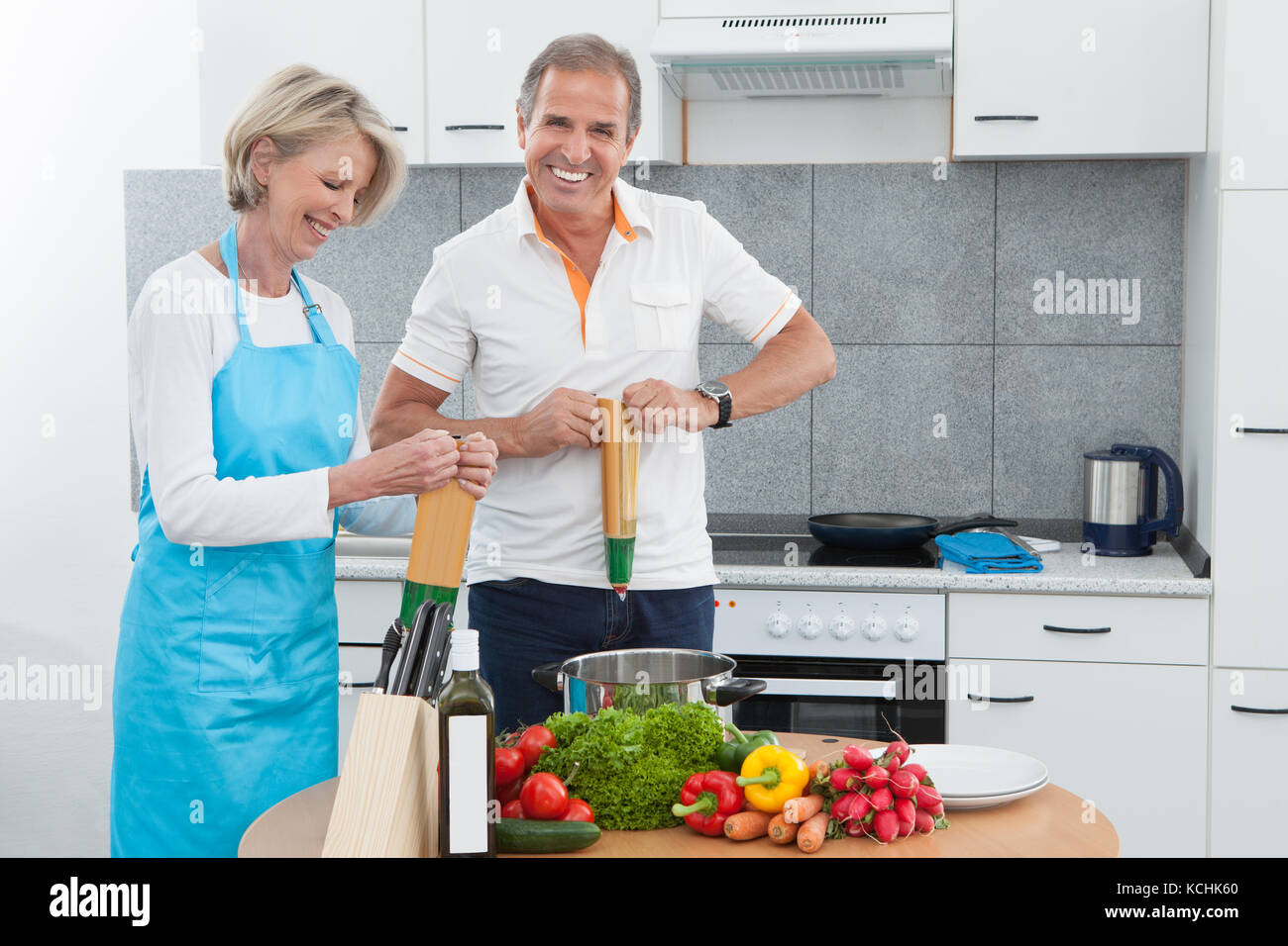 Mature couple cooking together hi-res stock photography and images - Alamy