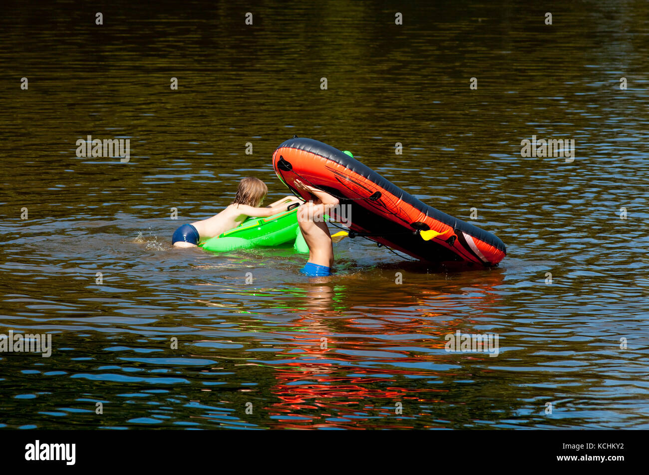 Two Boys Having Fun on Inflatable Rubber Boat in Summer Stock Photo - Alamy