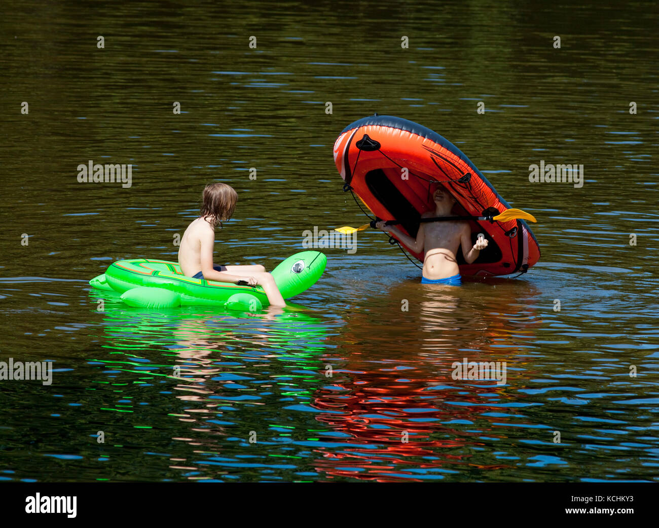 Two Boys Having Fun on Inflatable Rubber Boat in Summer Stock Photo - Alamy