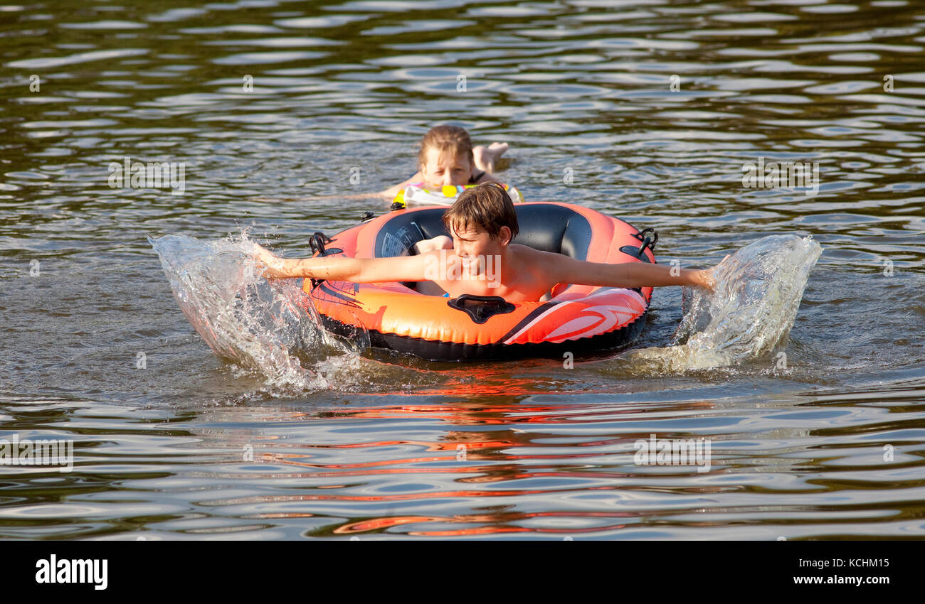 Two Boys Having Fun on Inflatable Rubber Boat in Summer Stock Photo - Alamy