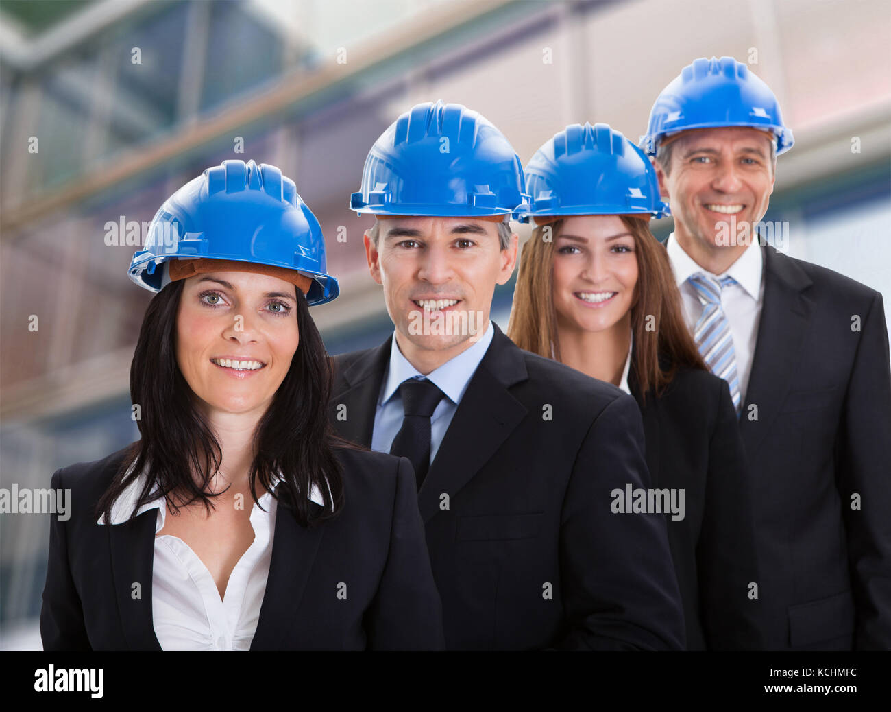 Portrait Of Happy Architects Wearing Helmet And Standing In A Row Stock ...
